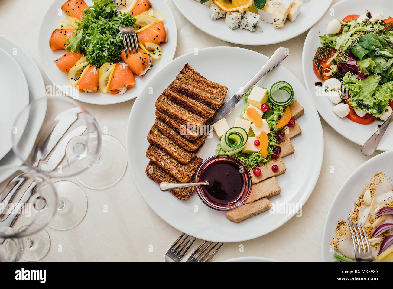 Served dishes to the table for holiday. Cutlery and food on white ...