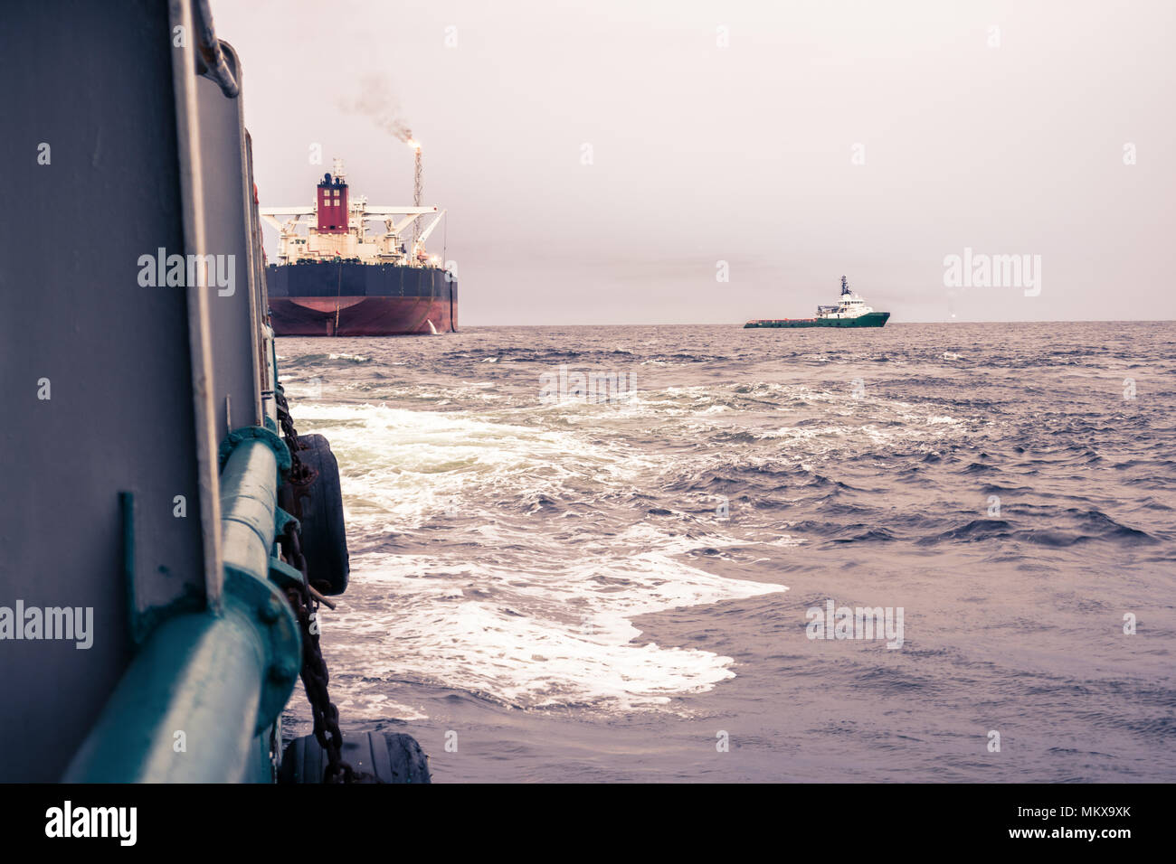Anchor-handling Tug Supply AHTS vessel at work with FPSO tanker Stock ...