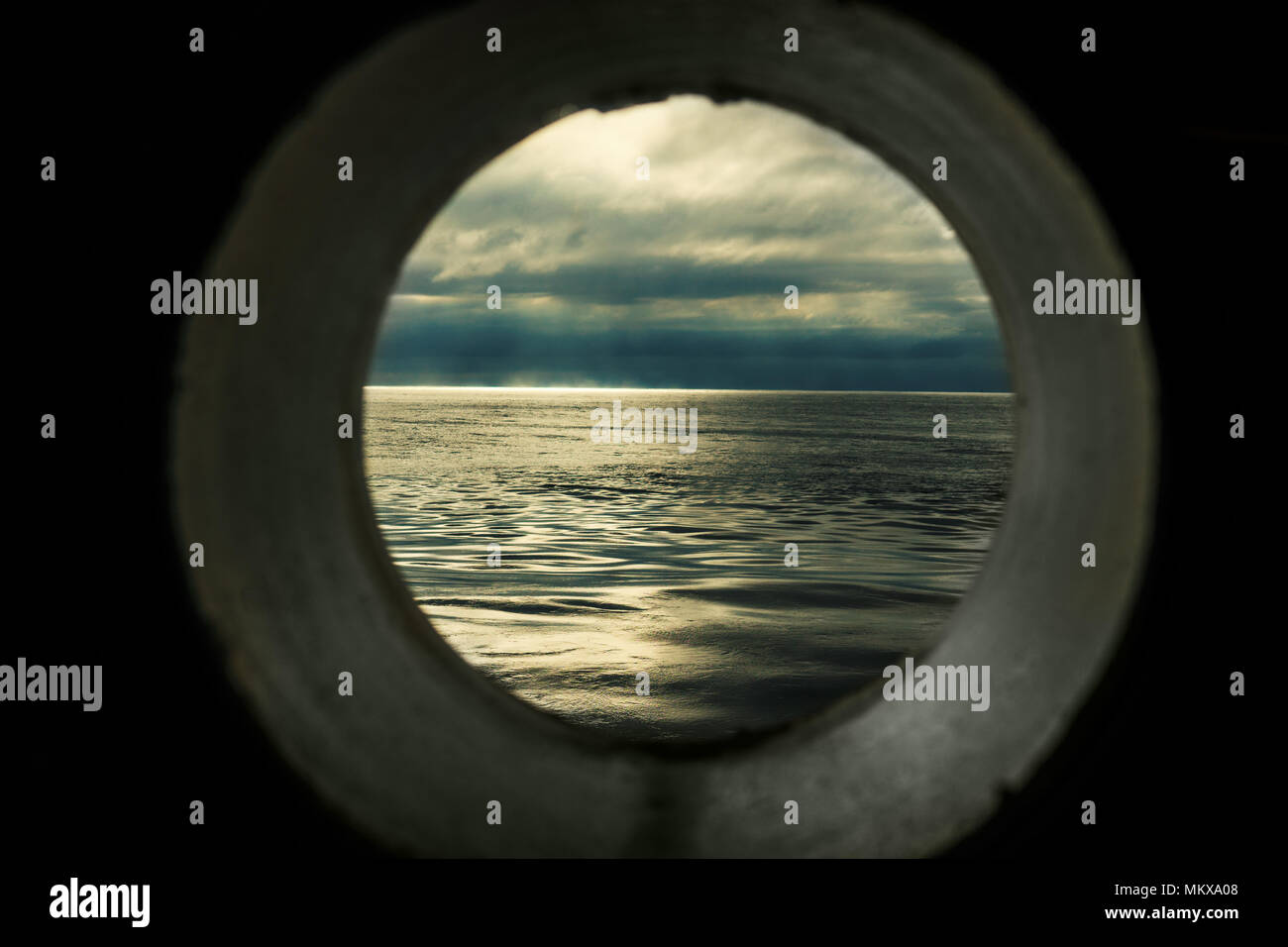 Ship window or porthole view with a relaxing seascape and dark grey ...