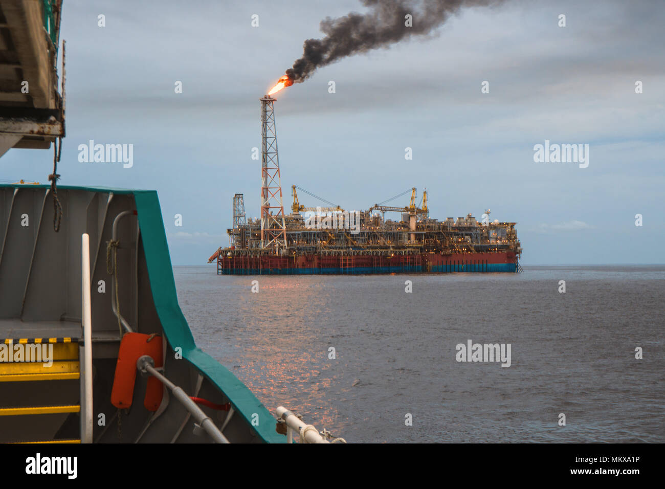 FPSO tanker vessel near Oil Rig platform. Offshore oil and gas industry ...