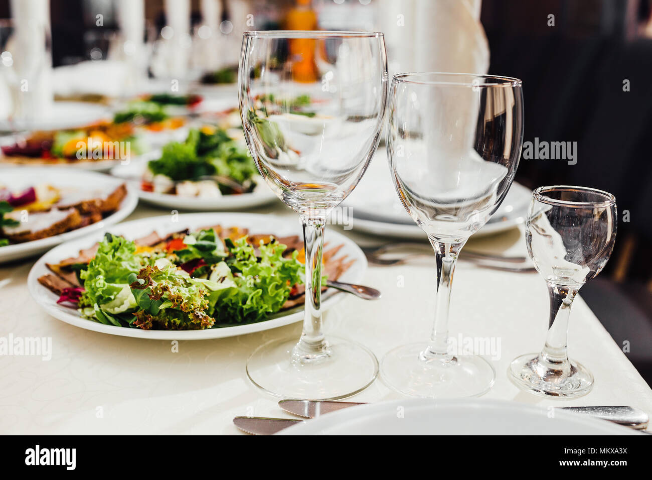 Served dishes to the table for holiday. Cutlery and food on white ...