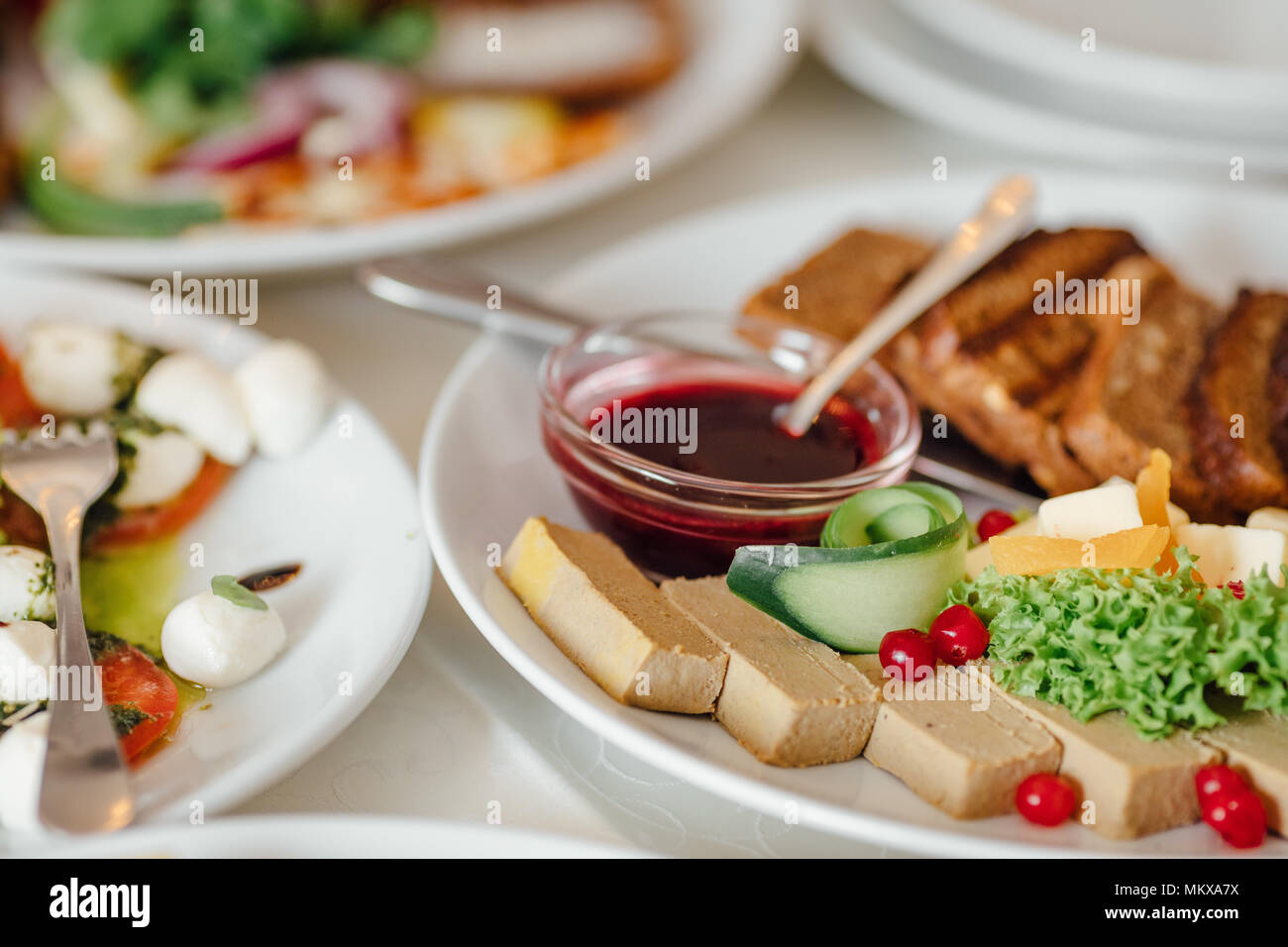 Served dishes to the table for holiday. Cutlery and food on white ...