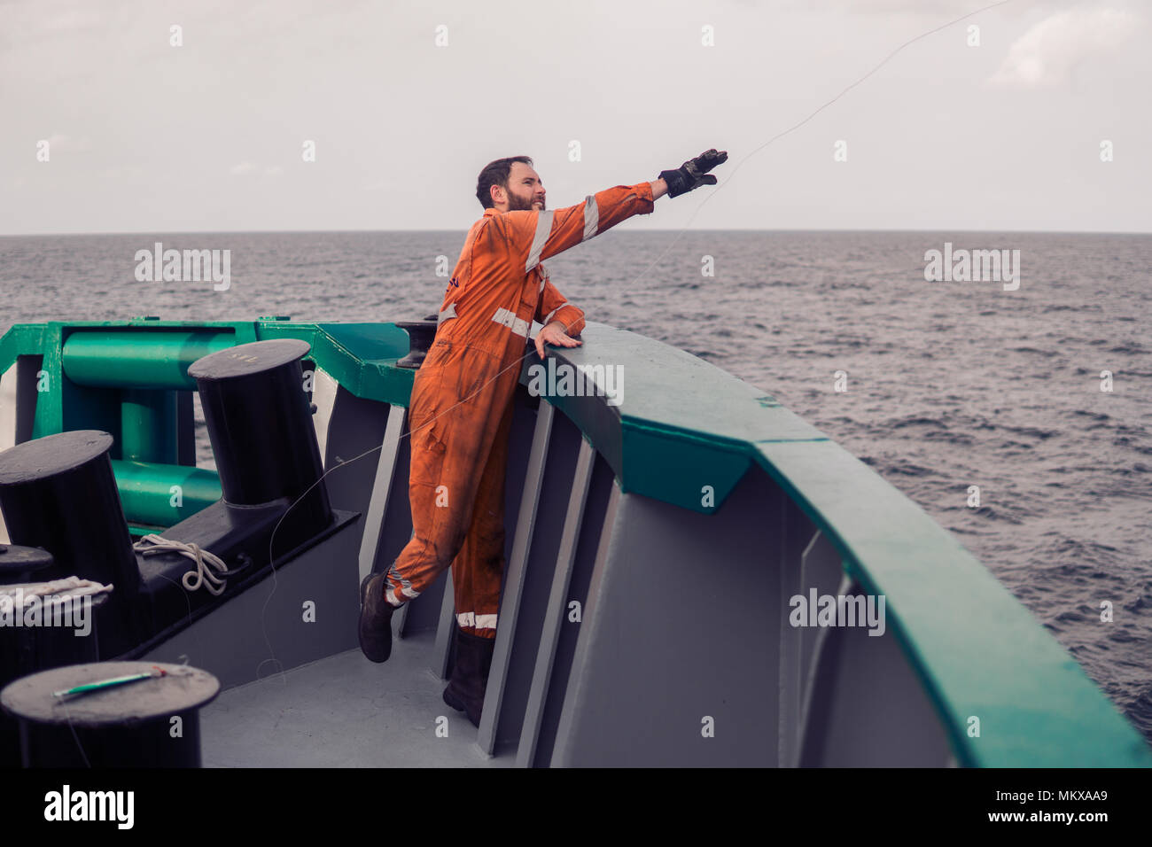 The fisherman throws a hook on a ship for catching tuna fish. Fishing ...