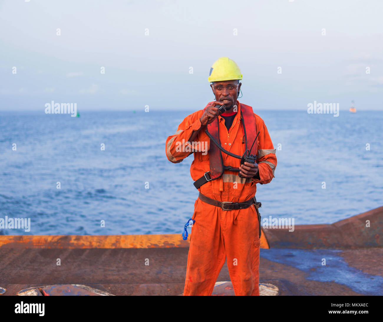 Seaman AB or Bosun on deck of offshore vessel or ship , wearing PPE ...