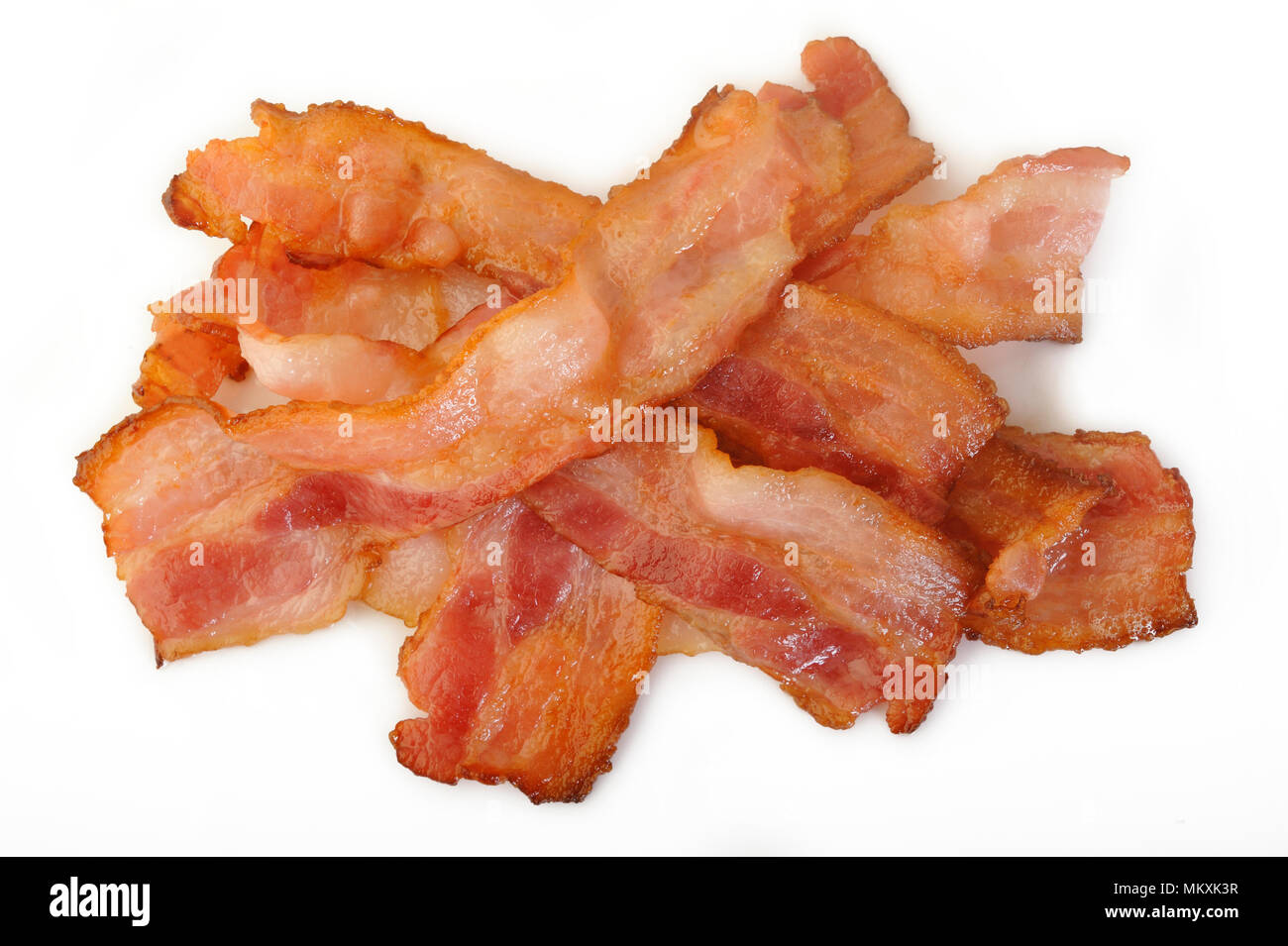 Cooked bacon rashers on white background Stock Photo - Alamy
