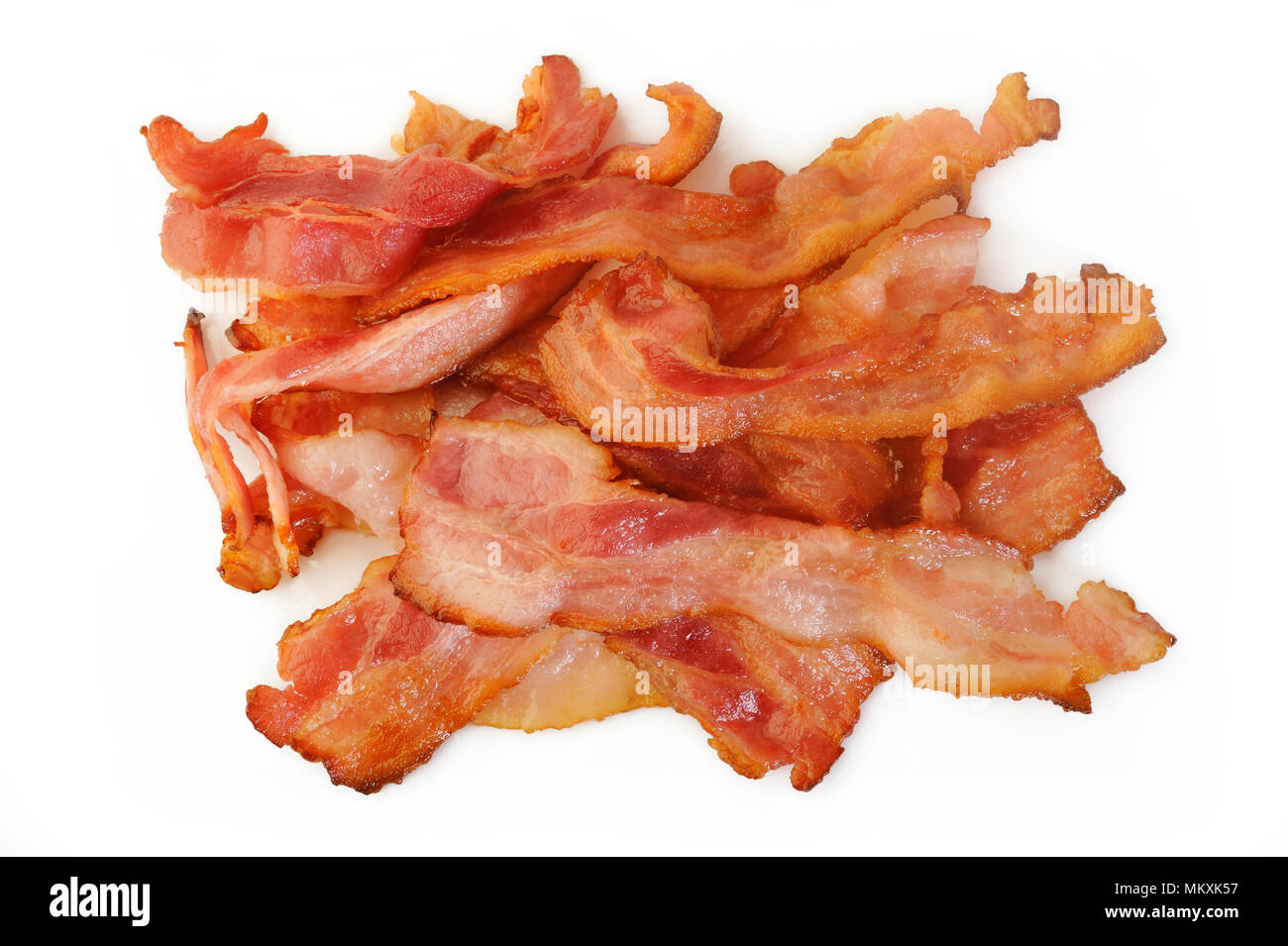 Cooked bacon rashers on white background Stock Photo - Alamy