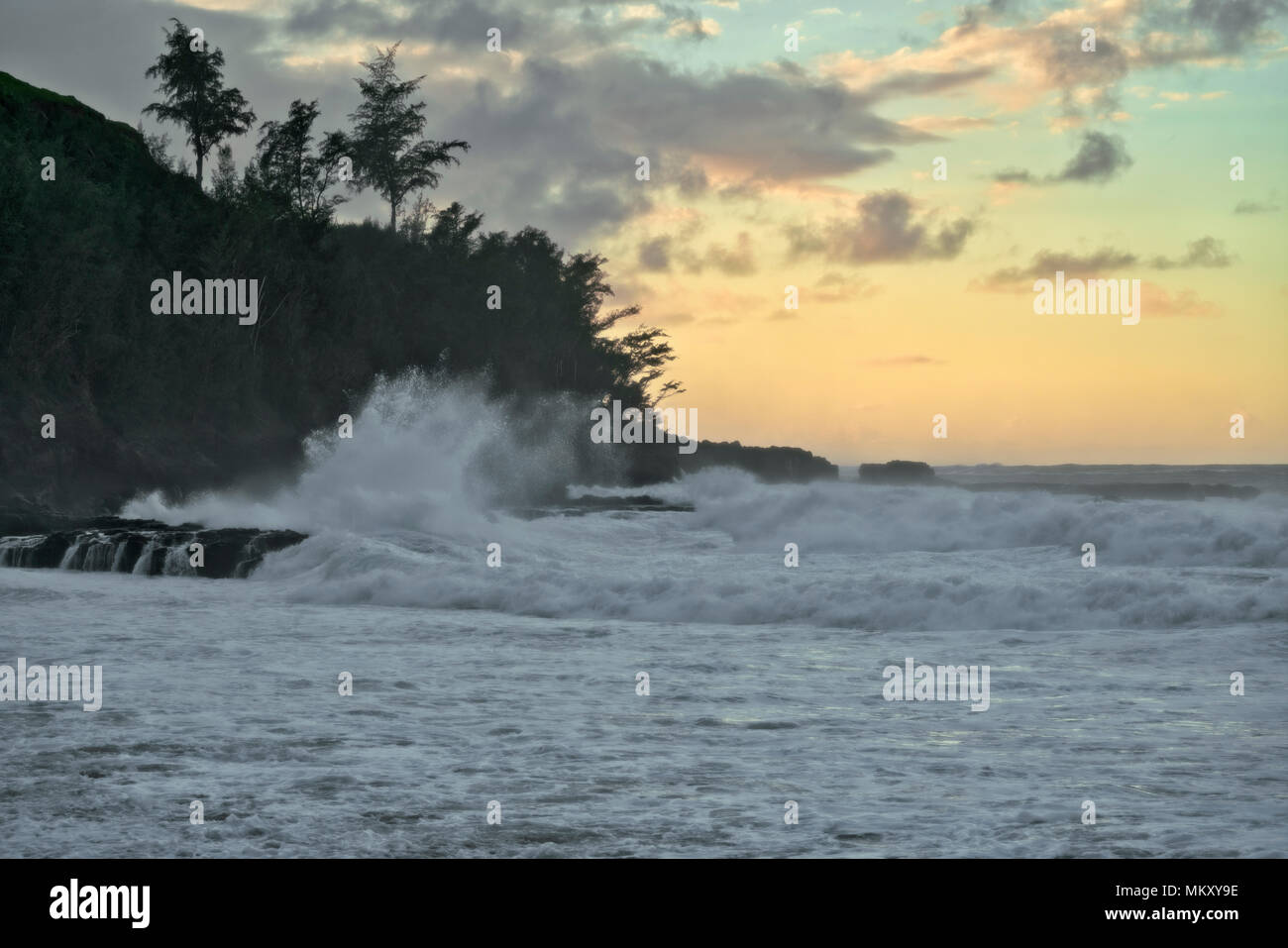 Sunset over Secret Beach as incoming waves pound the North Shore on ...