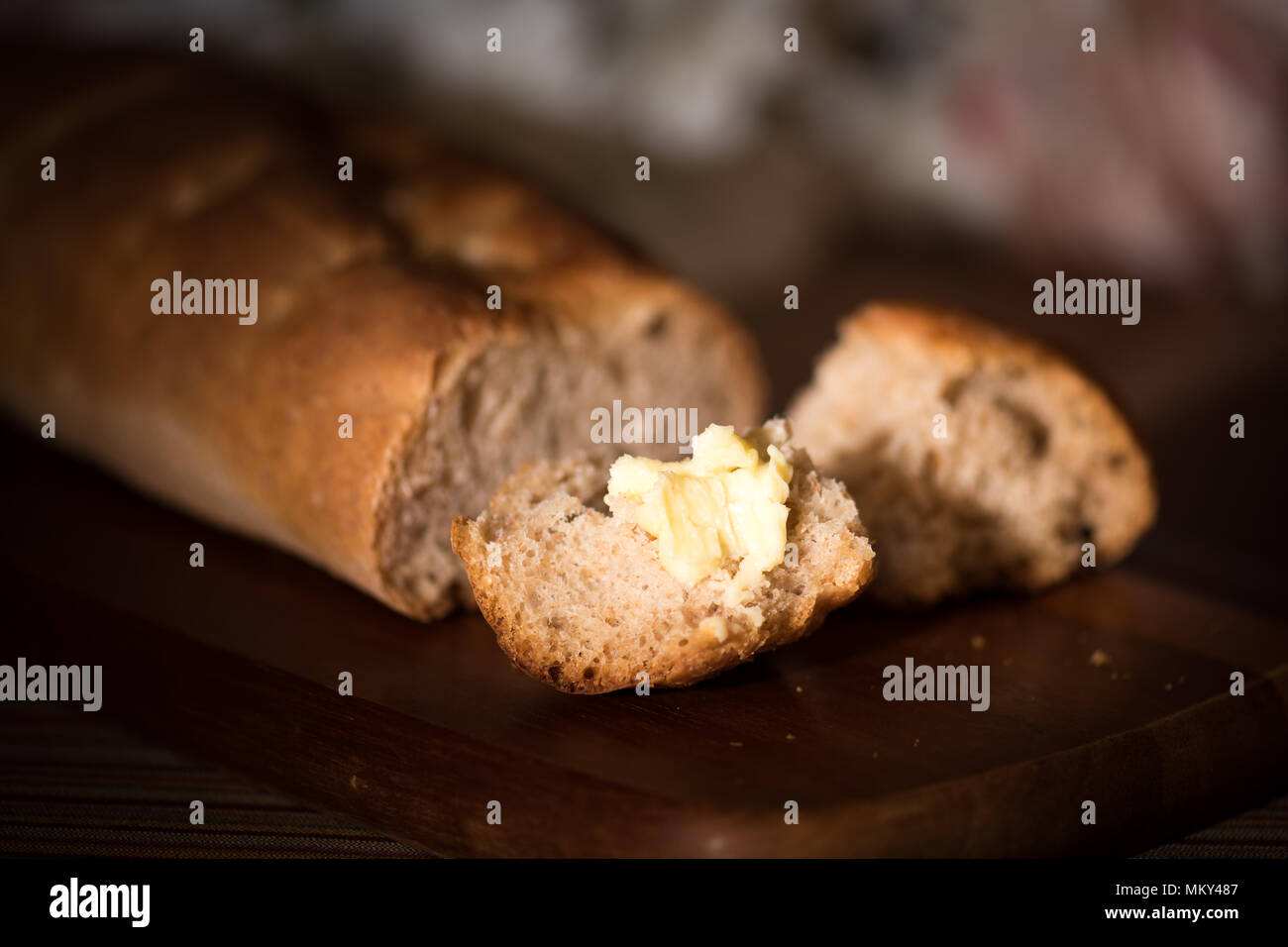 Rustic baguette with butter Stock Photo - Alamy