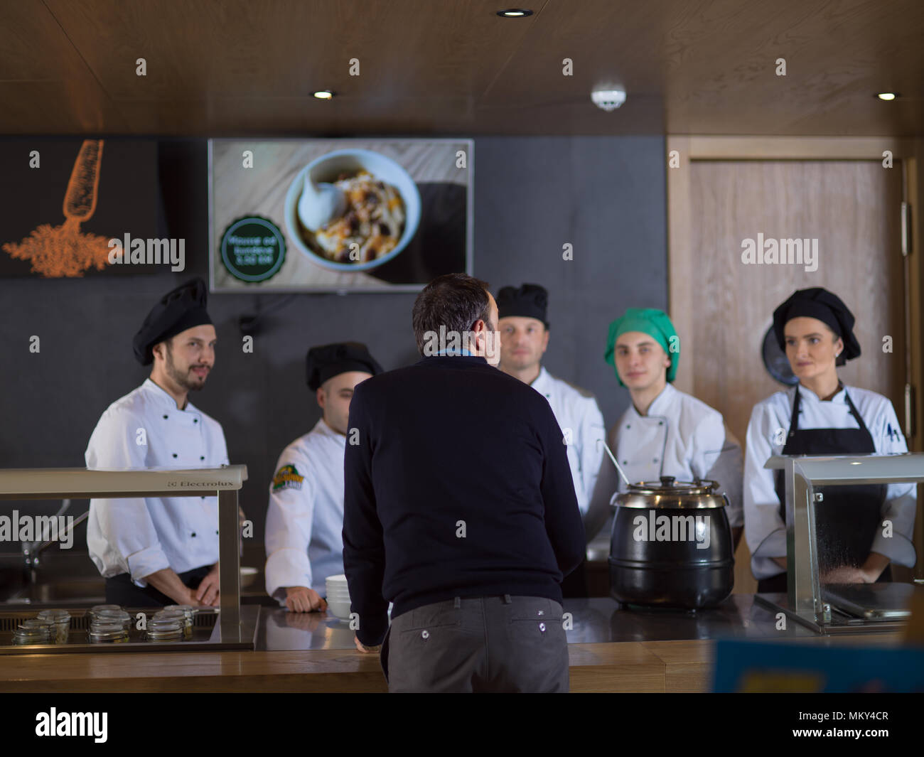 Team chefs in the kitchen presenting dish of tasty meal for restaurant ...