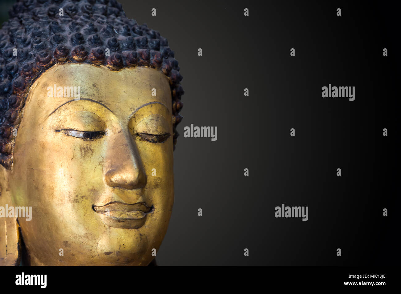 Close up face of Buddha statue on dark background used as amulets in ...