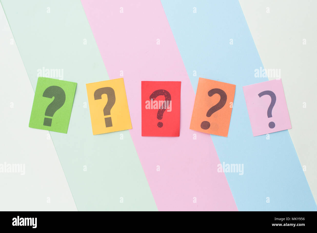 colorful paper with QUESTION MARK on multicolored pastel color ...