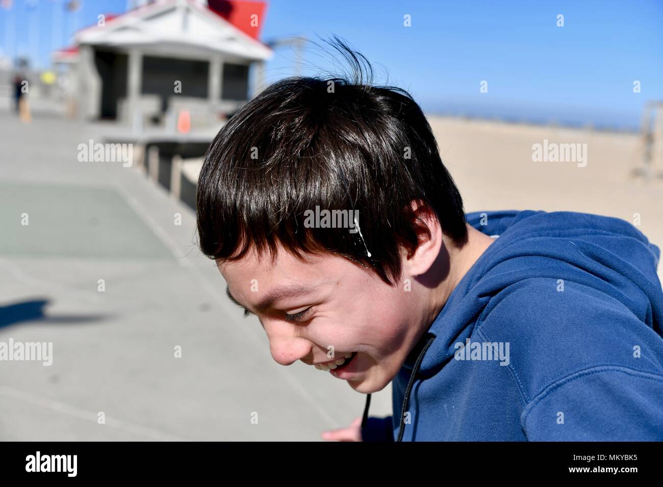 Teenage boy laughing after being hit by bird poop from a seagull Stock ...