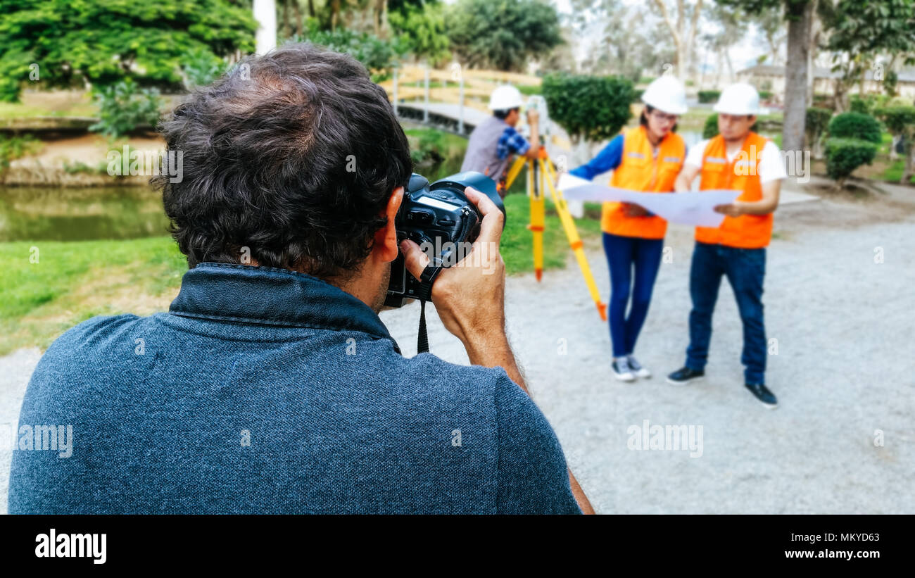 The photographer takes a photo of a group of engineers Stock Photo - Alamy