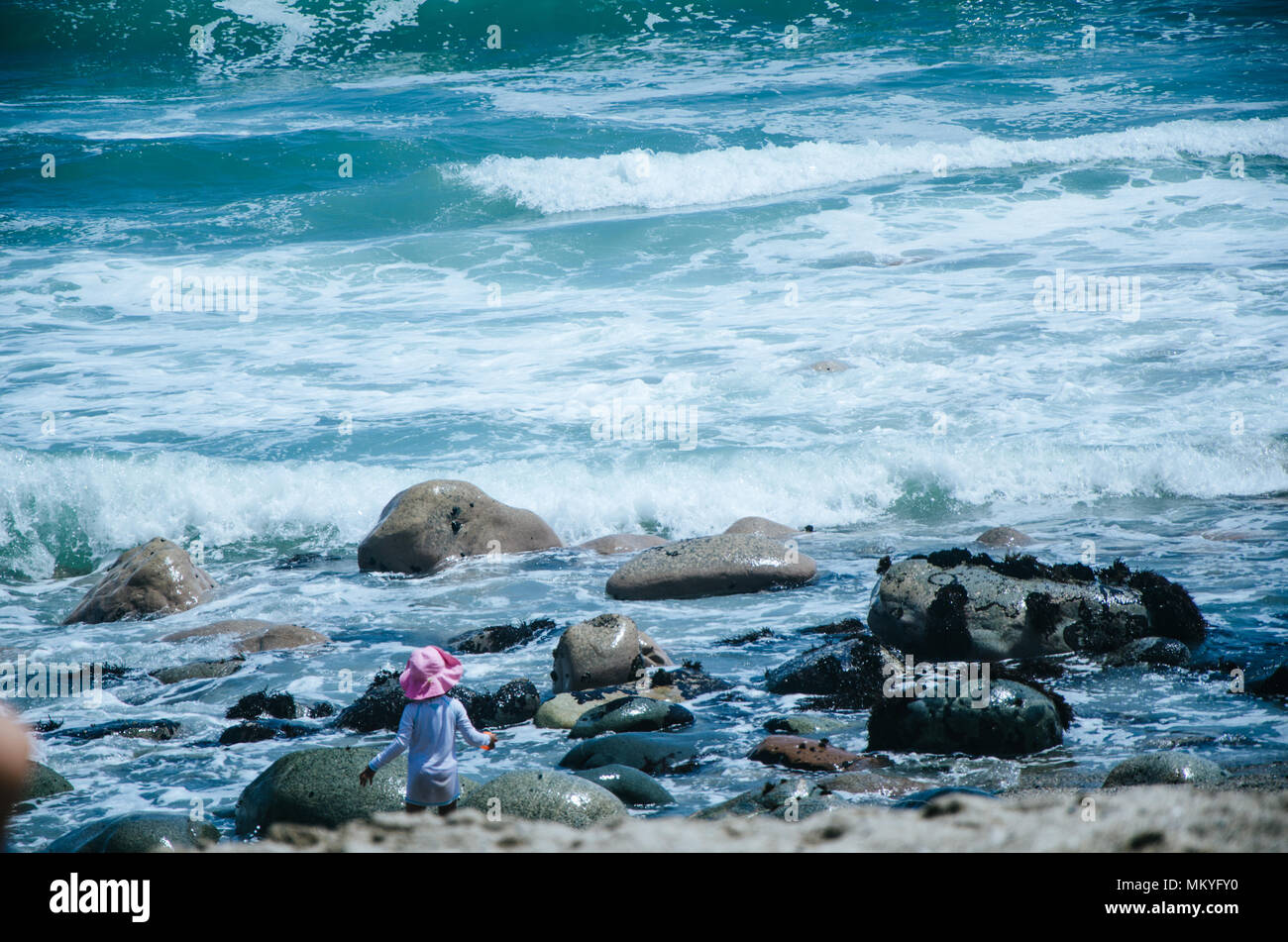 Boy playing on the seashore Stock Photo - Alamy
