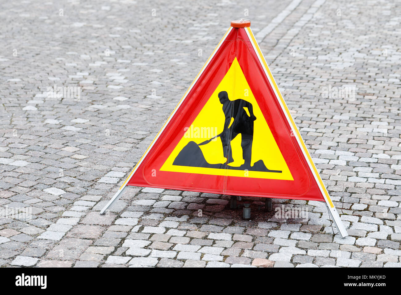 Temporary road sign roadworks installed on a street paved with ...
