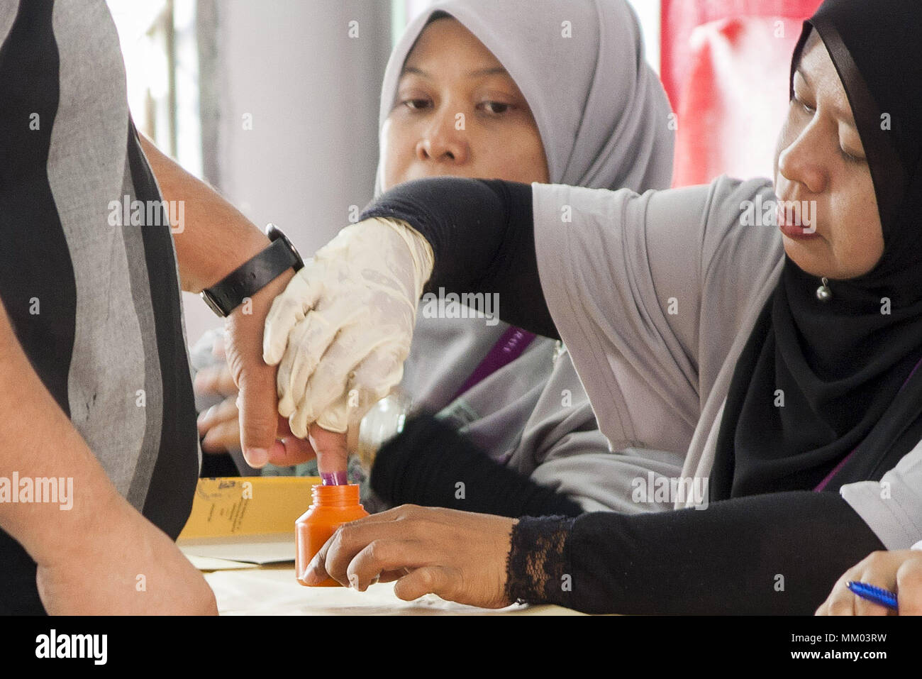 Kuala Lumpur, Malaysia. 9th May, 2018. A man seen dip his finger in the ...