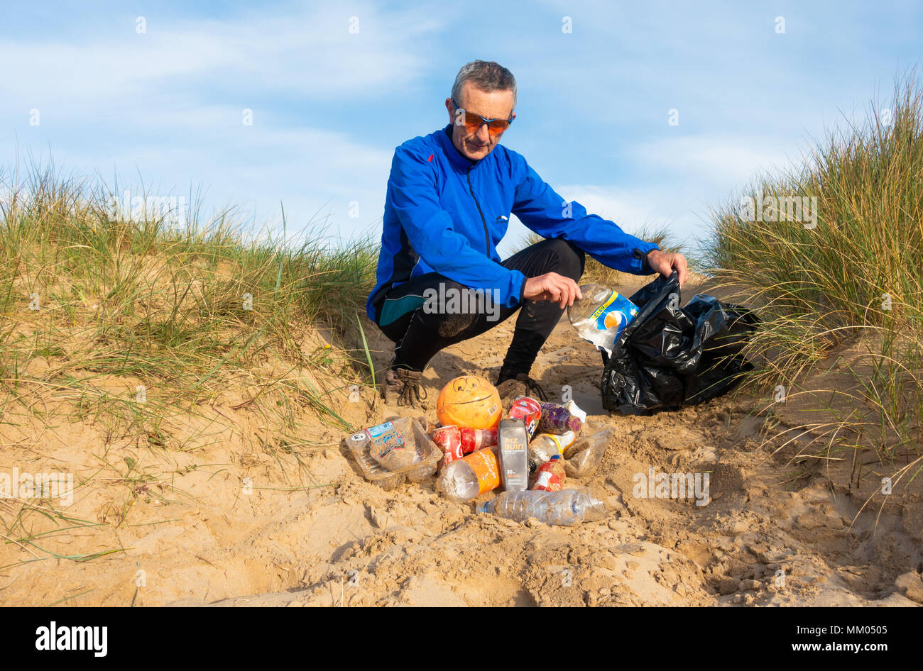 A jogger Plogging (picking up litter while jogging) on his morning run ...