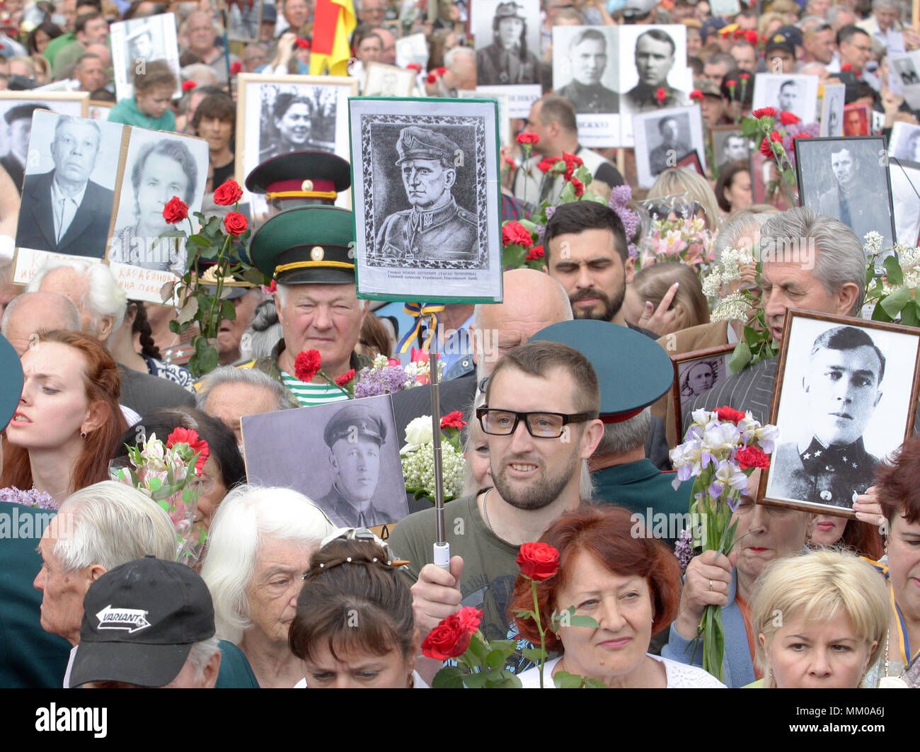 Kyiv, Ukraine. 9th May, 2018. The man holds a portrait of one of the ...
