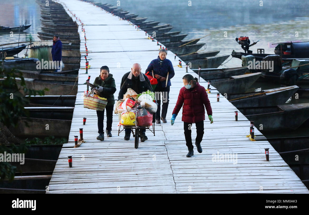 Ganzh, China. 9th May, 2018. Local people walk on the ancient pontoon ...