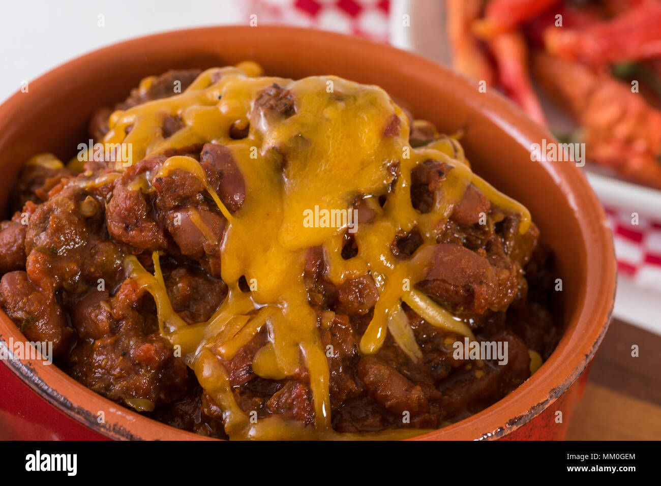 spicy Beef and Bean Chili with cheddar cheese, on white Stock Photo - Alamy
