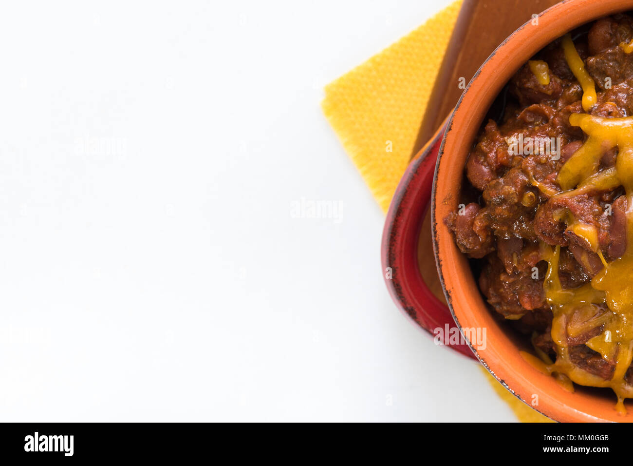 spicy Beef and Bean Chili with cheddar cheese, on white, with copy ...