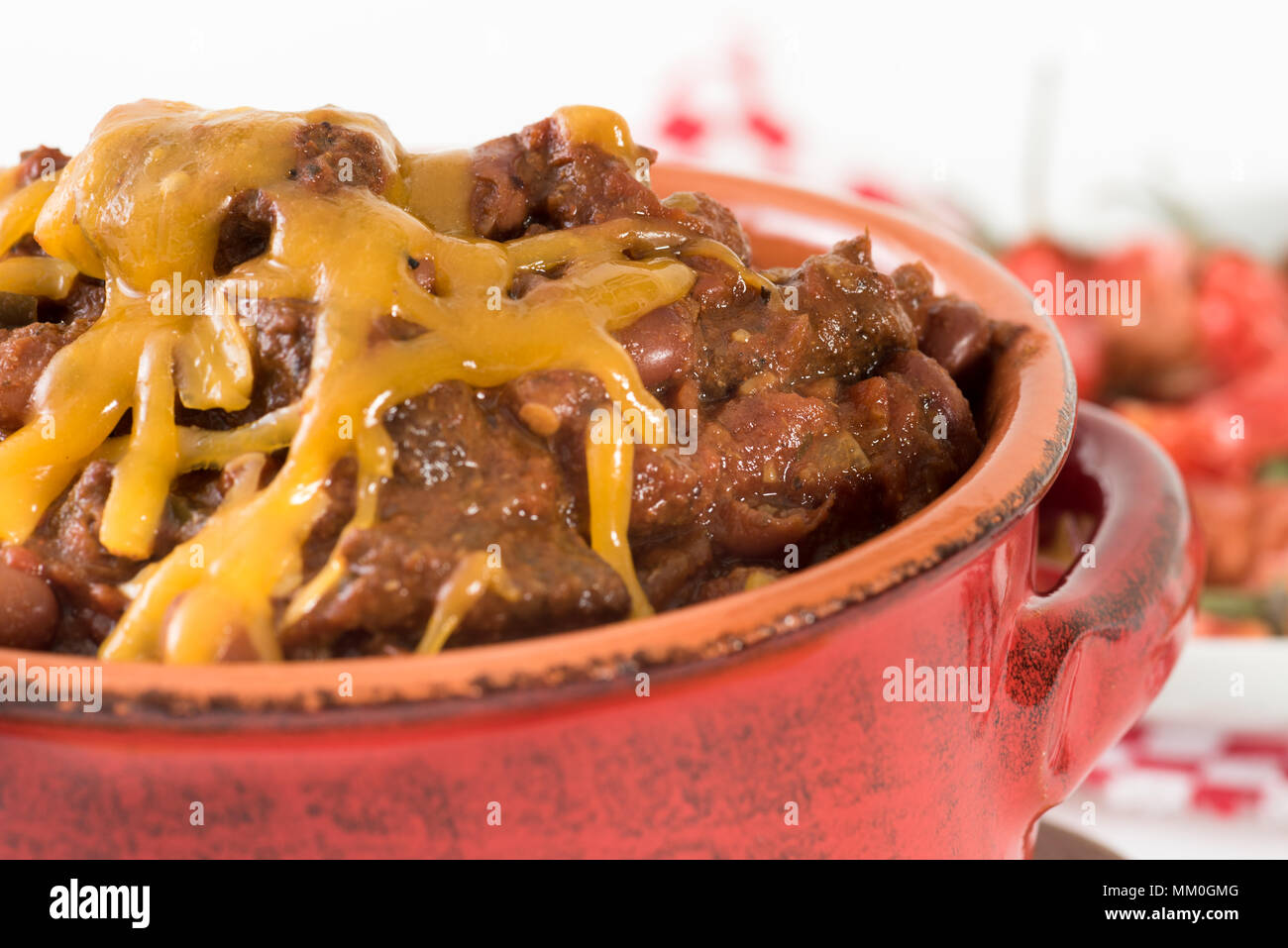 spicy Beef and Bean Chili with cheddar cheese, on white Stock Photo - Alamy