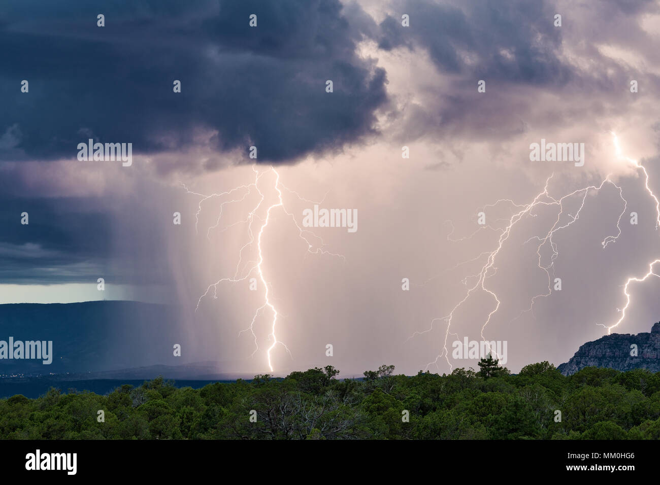 A strong summer thunderstorm with bright lightning bolts and heavy rain ...