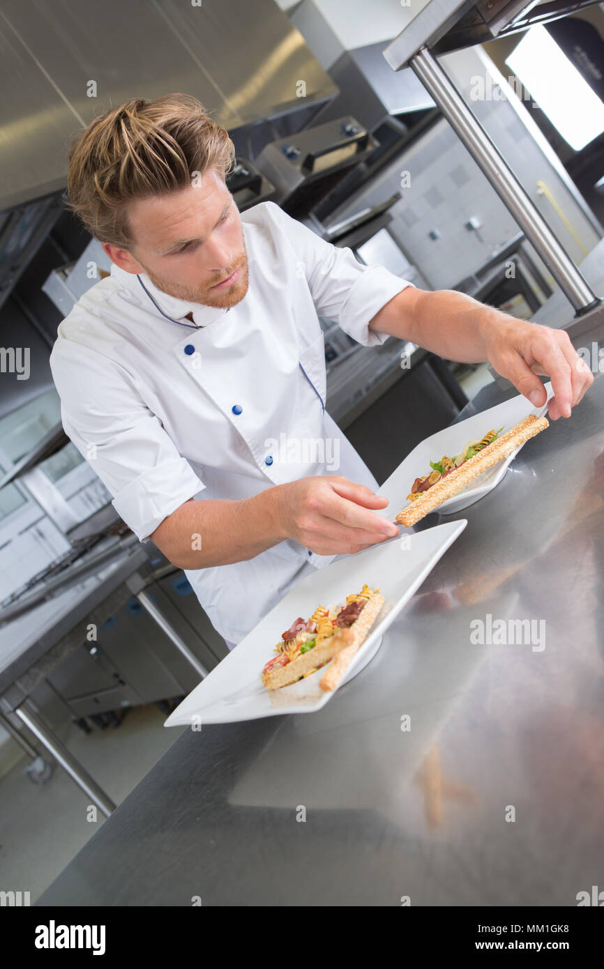 Hand presenting food plate hi-res stock photography and images - Alamy