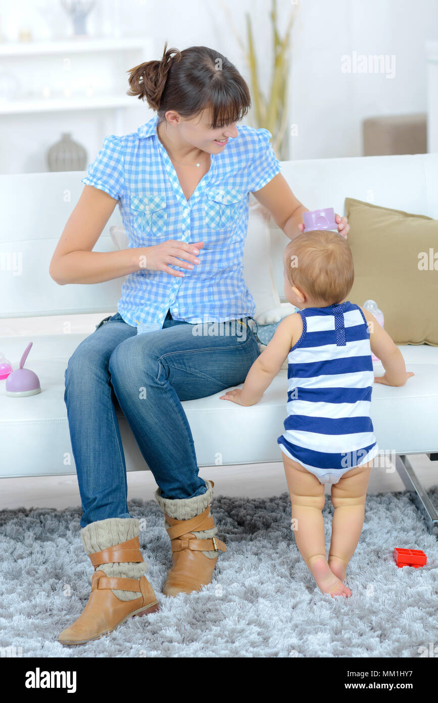 mom teaching baby to walk Stock Photo - Alamy