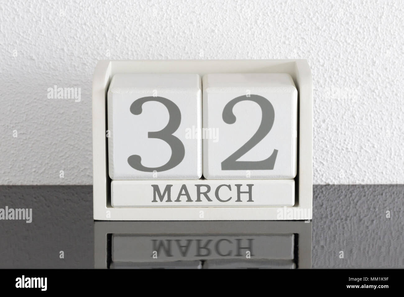 White block calendar present date 32 and month March on white wall ...