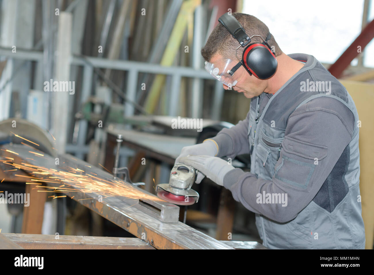 Man using angle grinder Stock Photo - Alamy