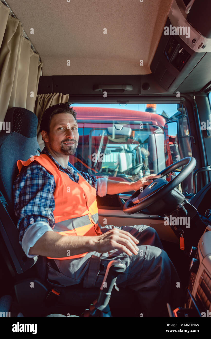 Lorry or truck driver sitting in the cabin of his vehicle Stock Photo ...