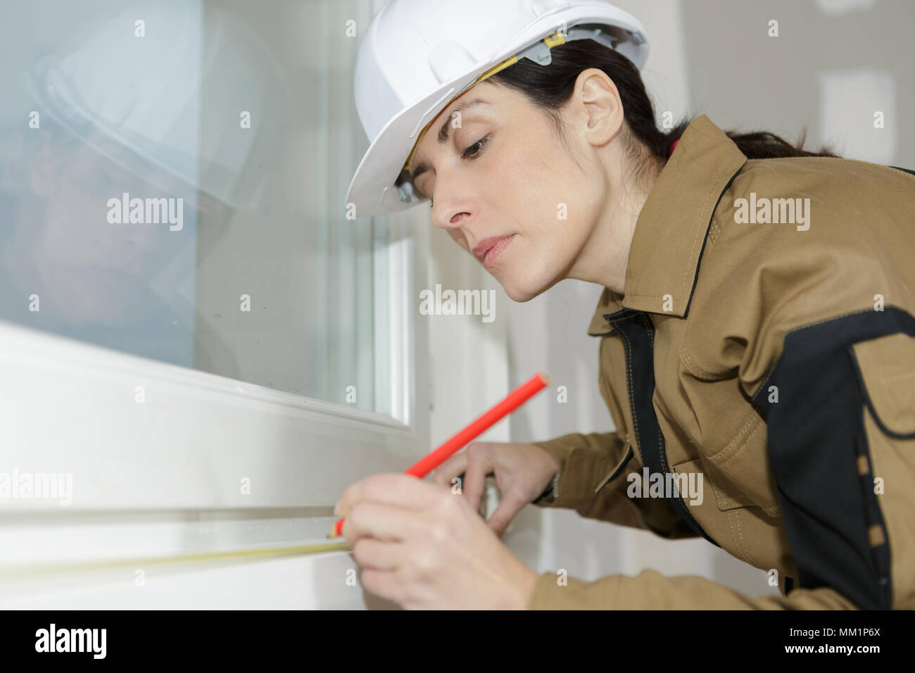 Woman measuring window frame Stock Photo - Alamy