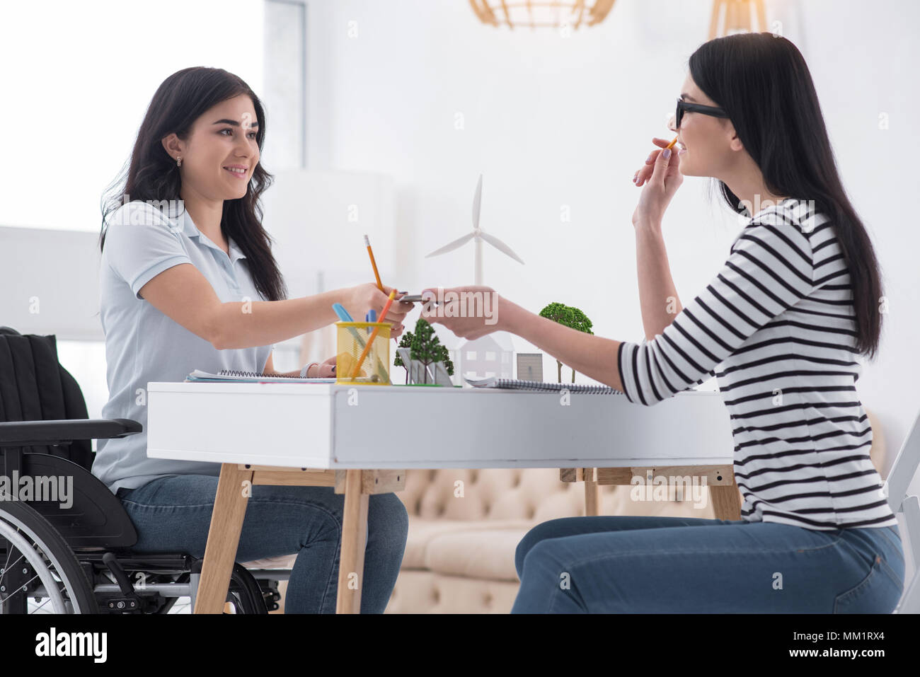Pretty female engineers changing energy supply Stock Photo - Alamy