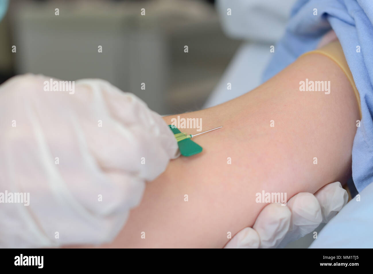 Needle being inserted into arm Stock Photo - Alamy