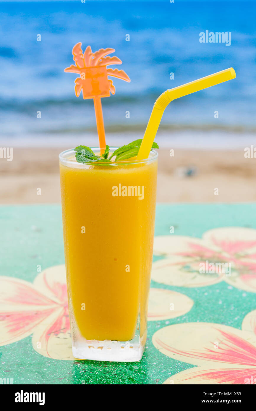 Mango shake with straw on the tropical beach Stock Photo - Alamy