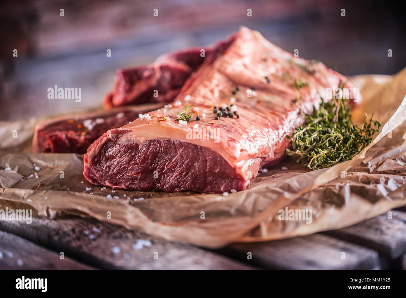 Raw rib eye beef steak with salt spices and herbs Stock Photo - Alamy