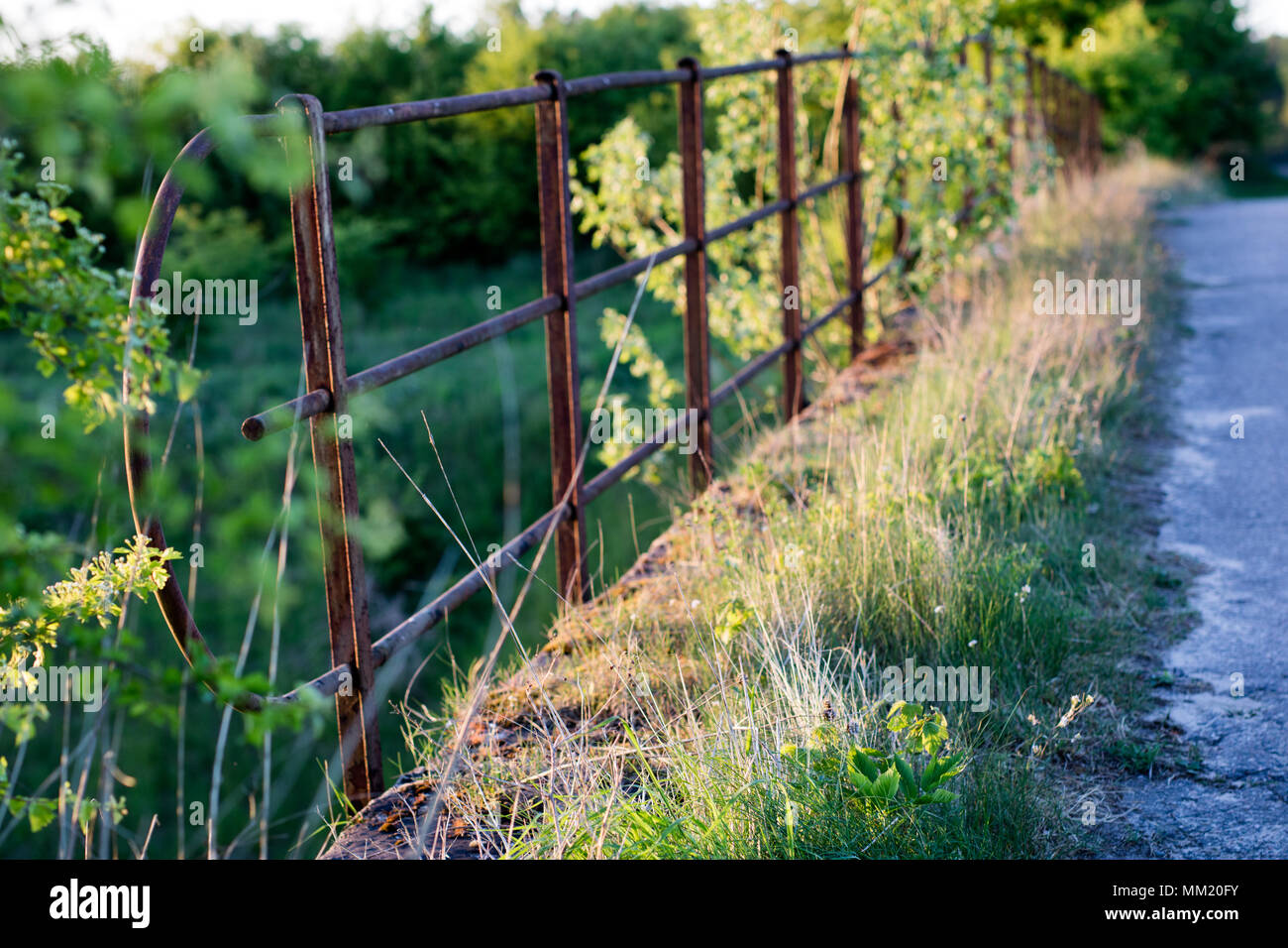Steel handrail of the railway viaduct. Old rusty barrier on a brick ...