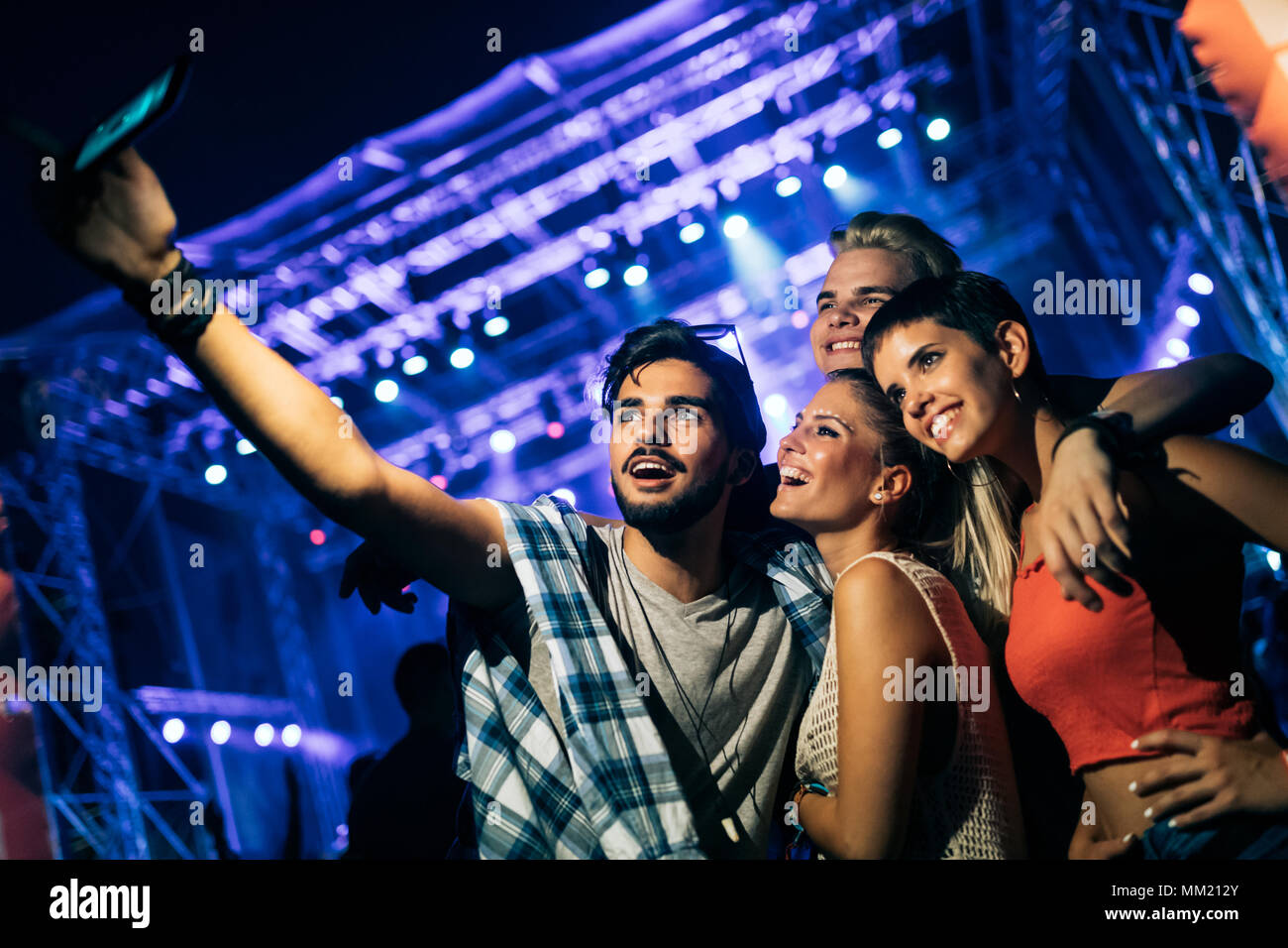 Happy friends having fun at music festival Stock Photo - Alamy