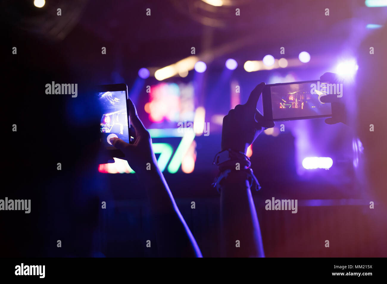 Picture of people recording music performance at festival Stock Photo ...