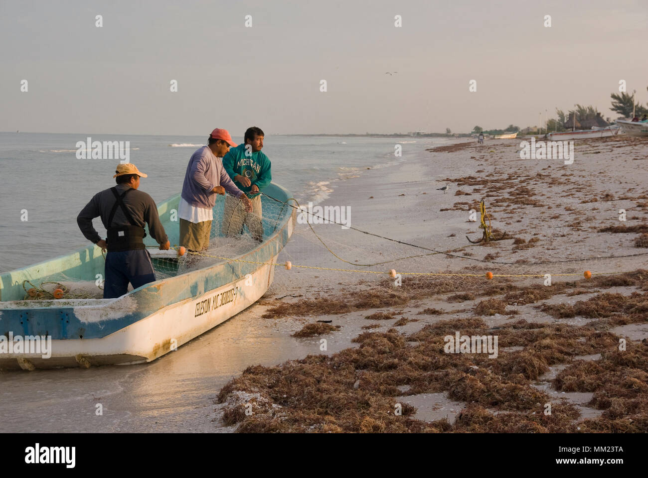 Mexican Fishermen in Boat Folding Net on Empty Tropical Beach, Celestun ...