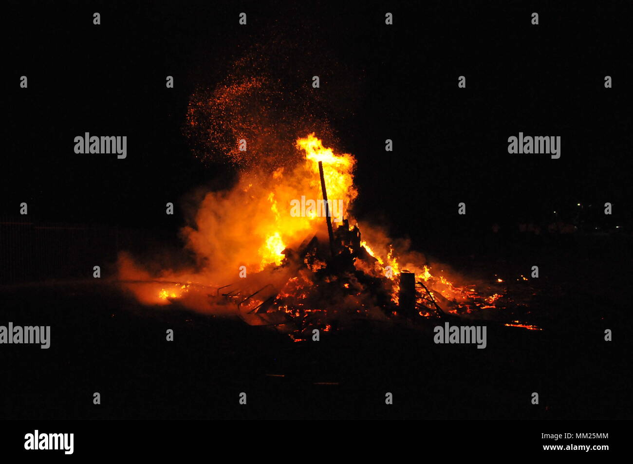 Firefighter extinguish a large bonfire during the lag b'omer celebrations (Lag B'Omer is a day ...