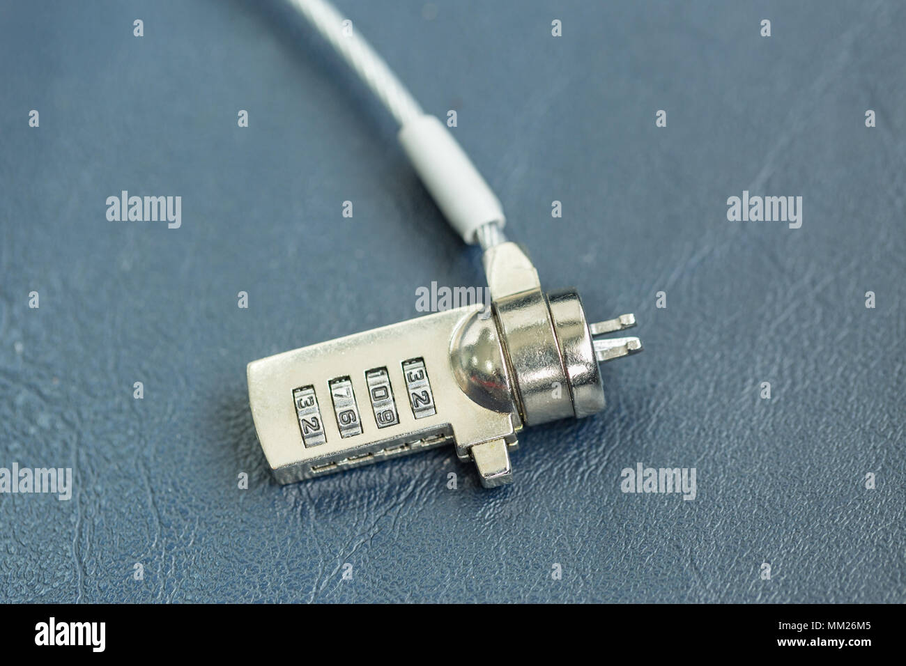 Computer cable lock on black leather, Security concept shot for the ...