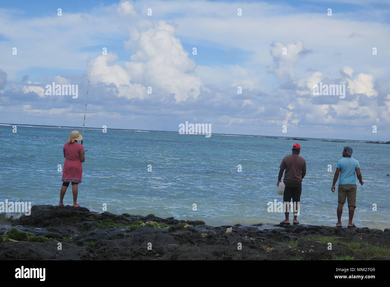 Local fisherman standing in Indian ocean, lagoon on Mauritius island ...