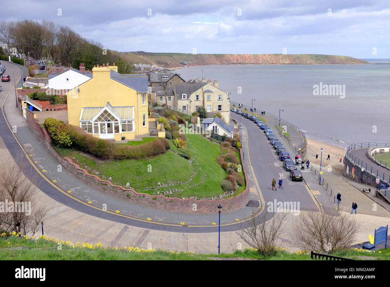 Filey, Yorkshire, UK. April 26, 2018. Holidaymakers walking the beach ...