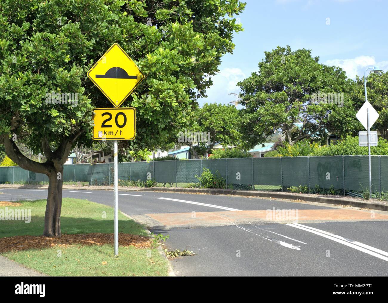 street-sign-post-with-20-km-per-hour-and-speed-bump-yellow-road-sign