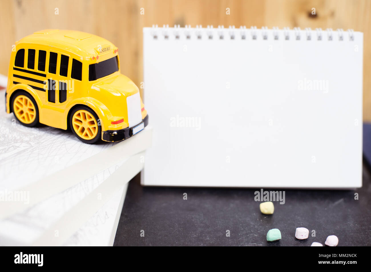 Back to school concept with school bus toy, books and blank note book ...