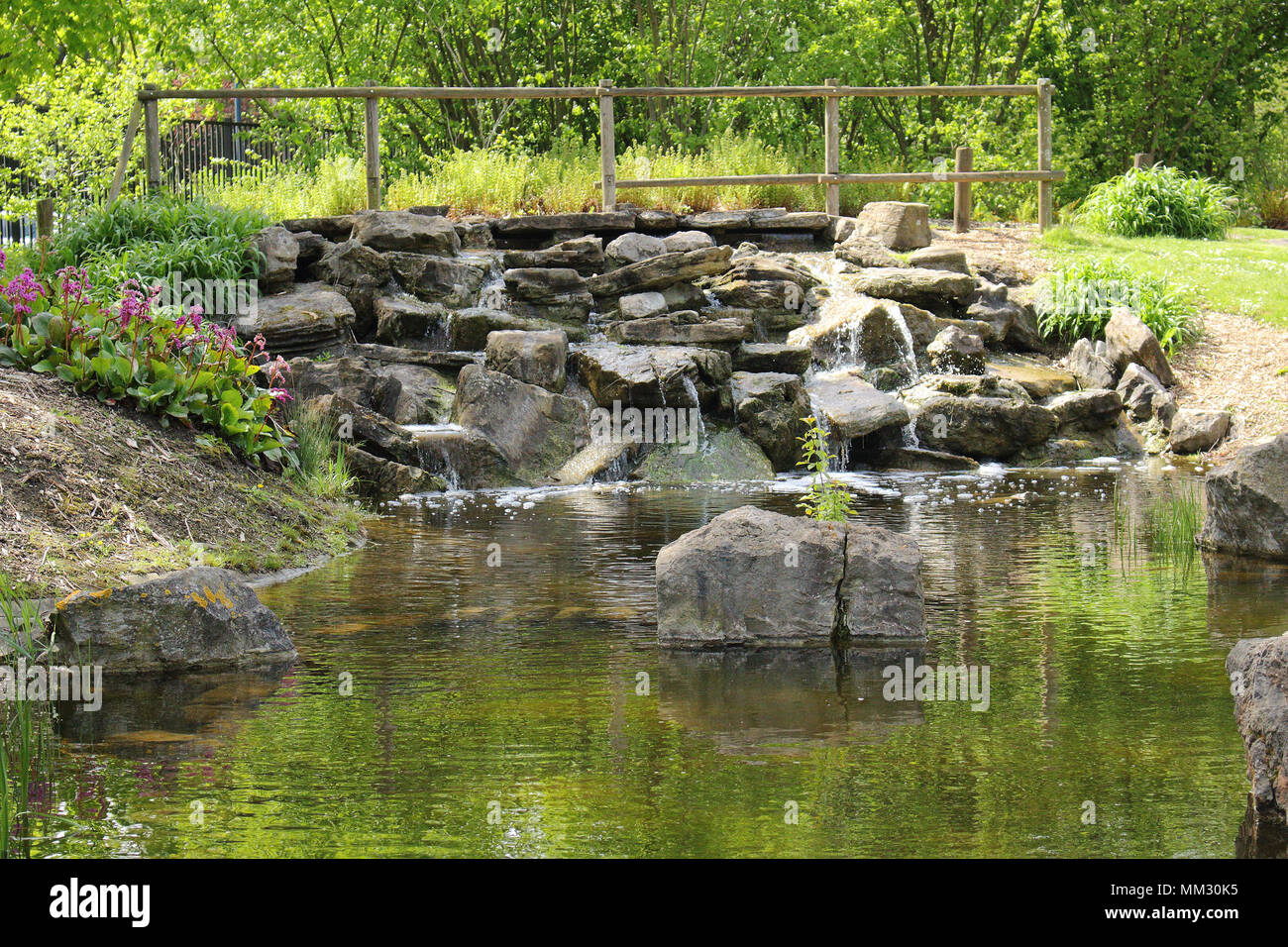 a waterfall with line writing with water and stones Stock Photo - Alamy