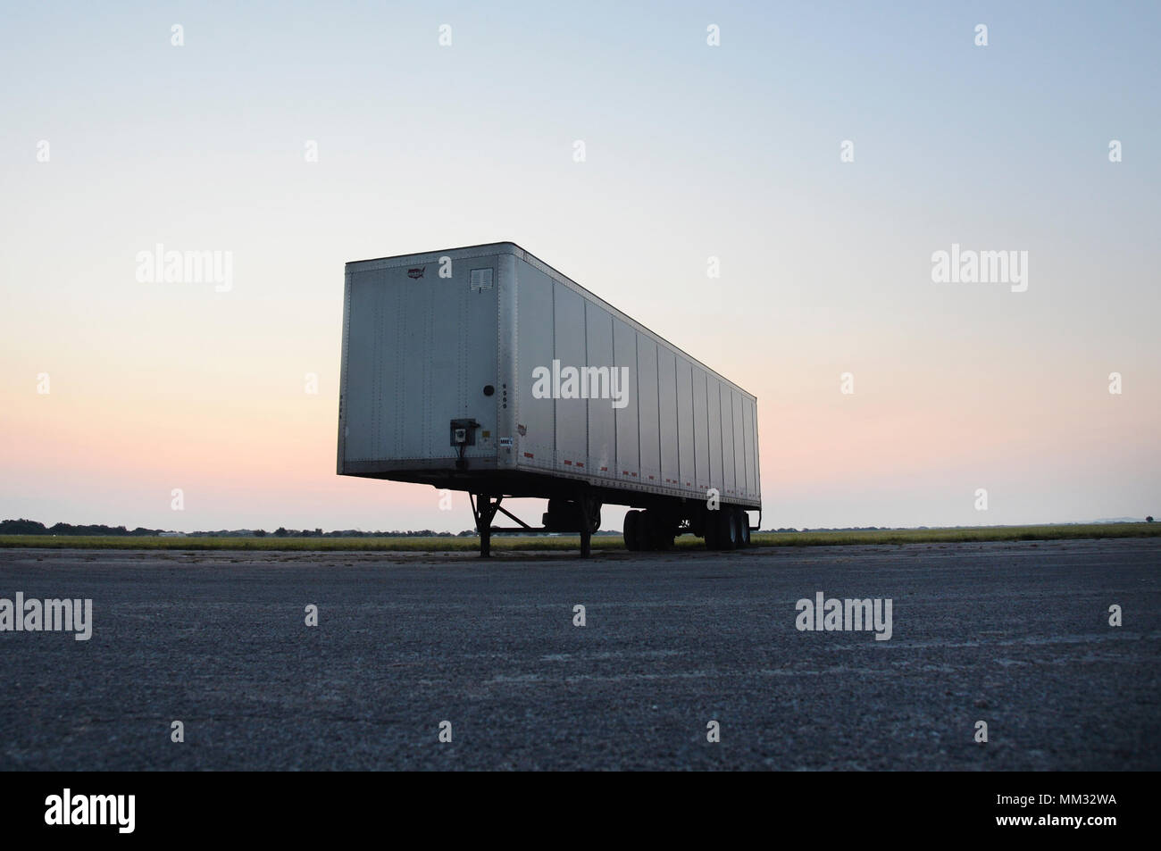 A hurricane relief trailer is silhouetted by the rising sun at JBSA ...