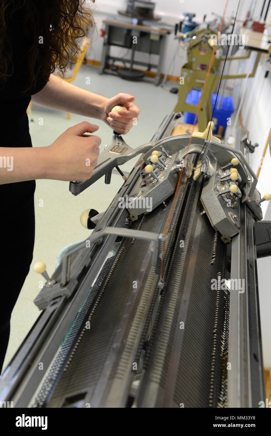 Young lady working on a traditional knitting machine Stock Photo - Alamy